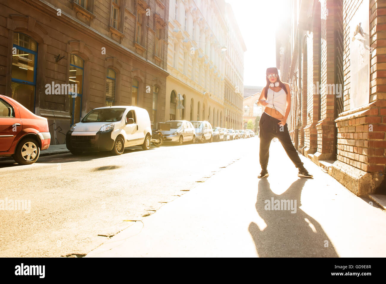 A beautiful young Hip Hop Rapper girl with Headphones in a urban ...