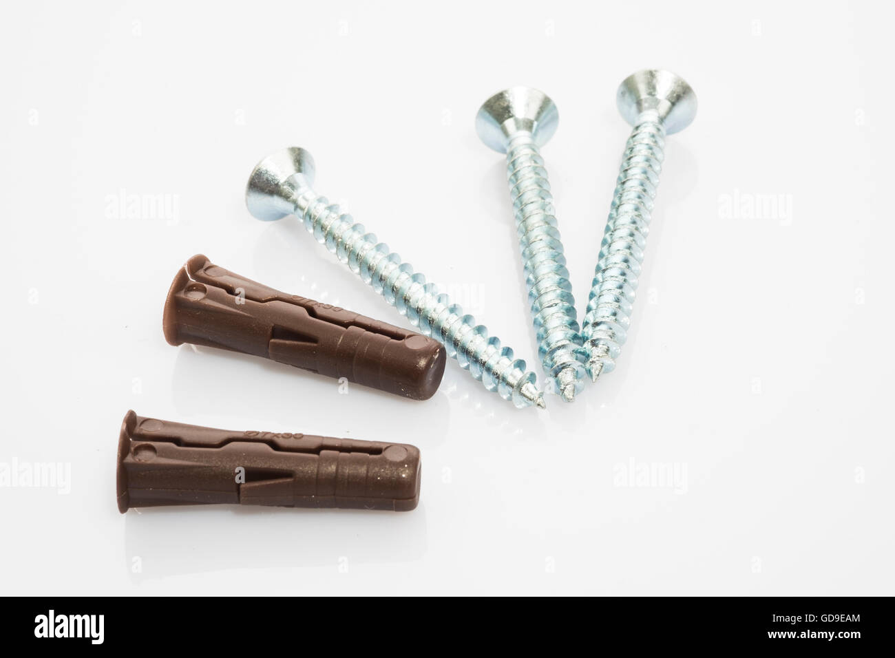 three screw and two raw plugs on white background Stock Photo - Alamy