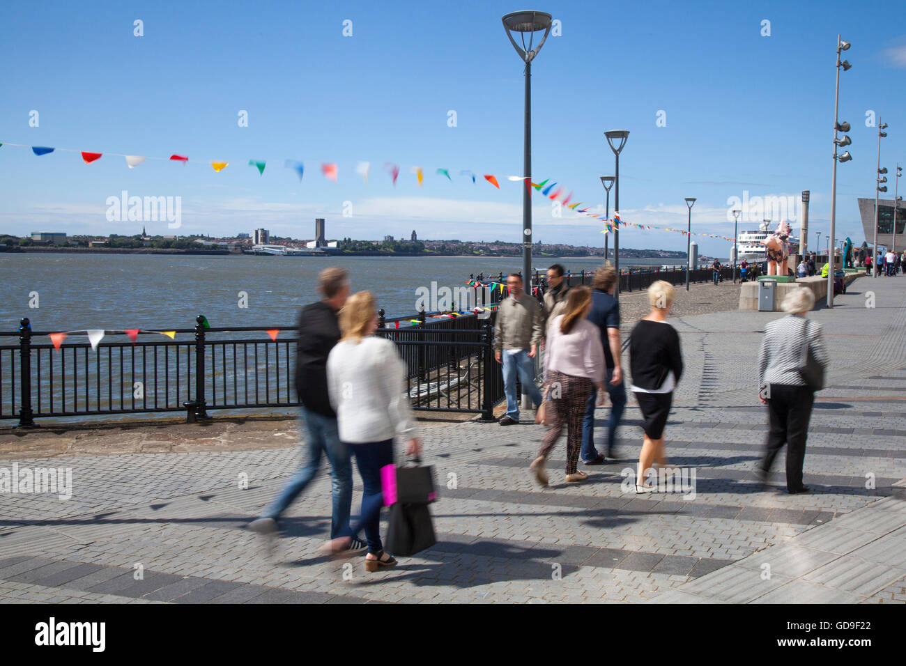 People enjoying the coastal riverside promenade on Liverpool’s ...