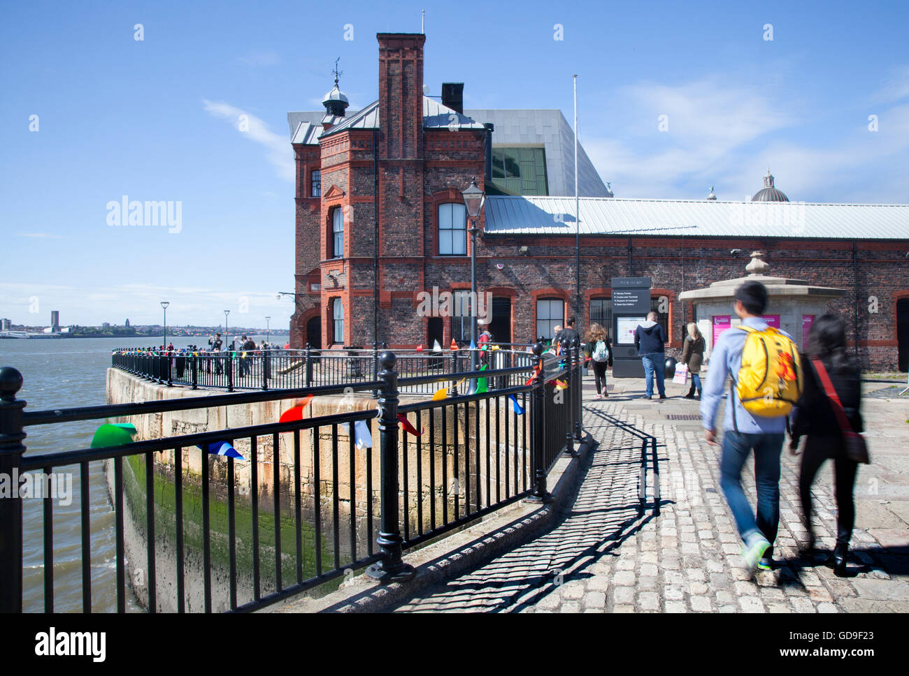 People enjoying the coastal riverside promenade on Liverpool’s ...