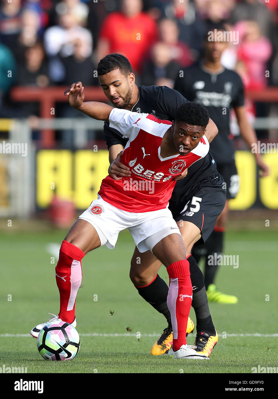 Liverpool's Kelviun Stewart (back) and Fleetwood Town's Keano Deacon in ...