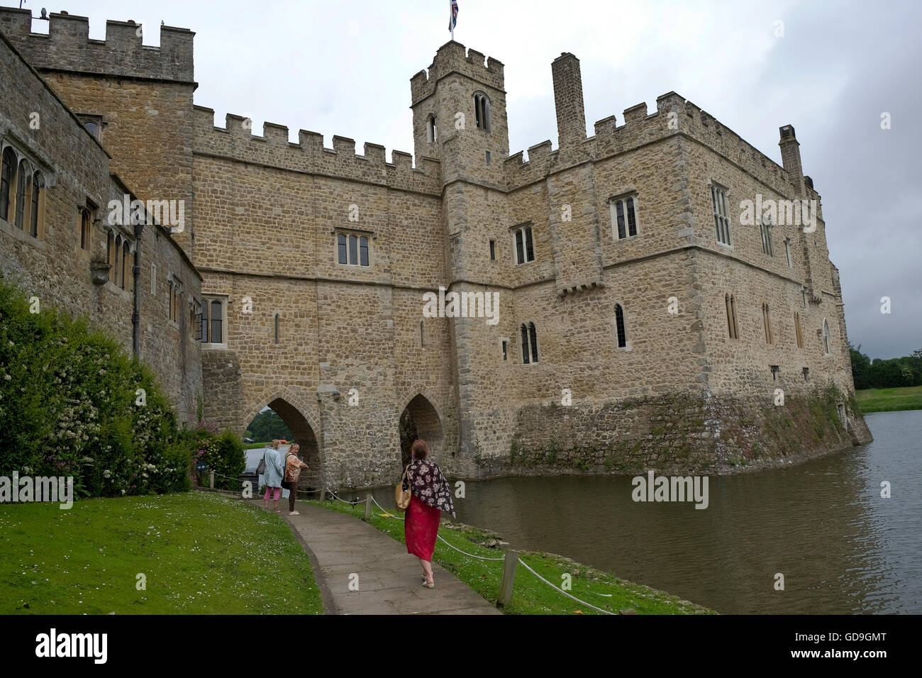 Tourists walk along the moat to the entrance of the tour of Leeds ...