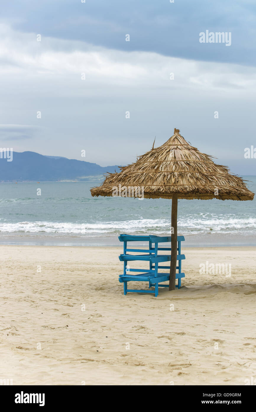 Sunbeds and Palm shelter in the China Beach in Da Nang, Vietnam. It is ...