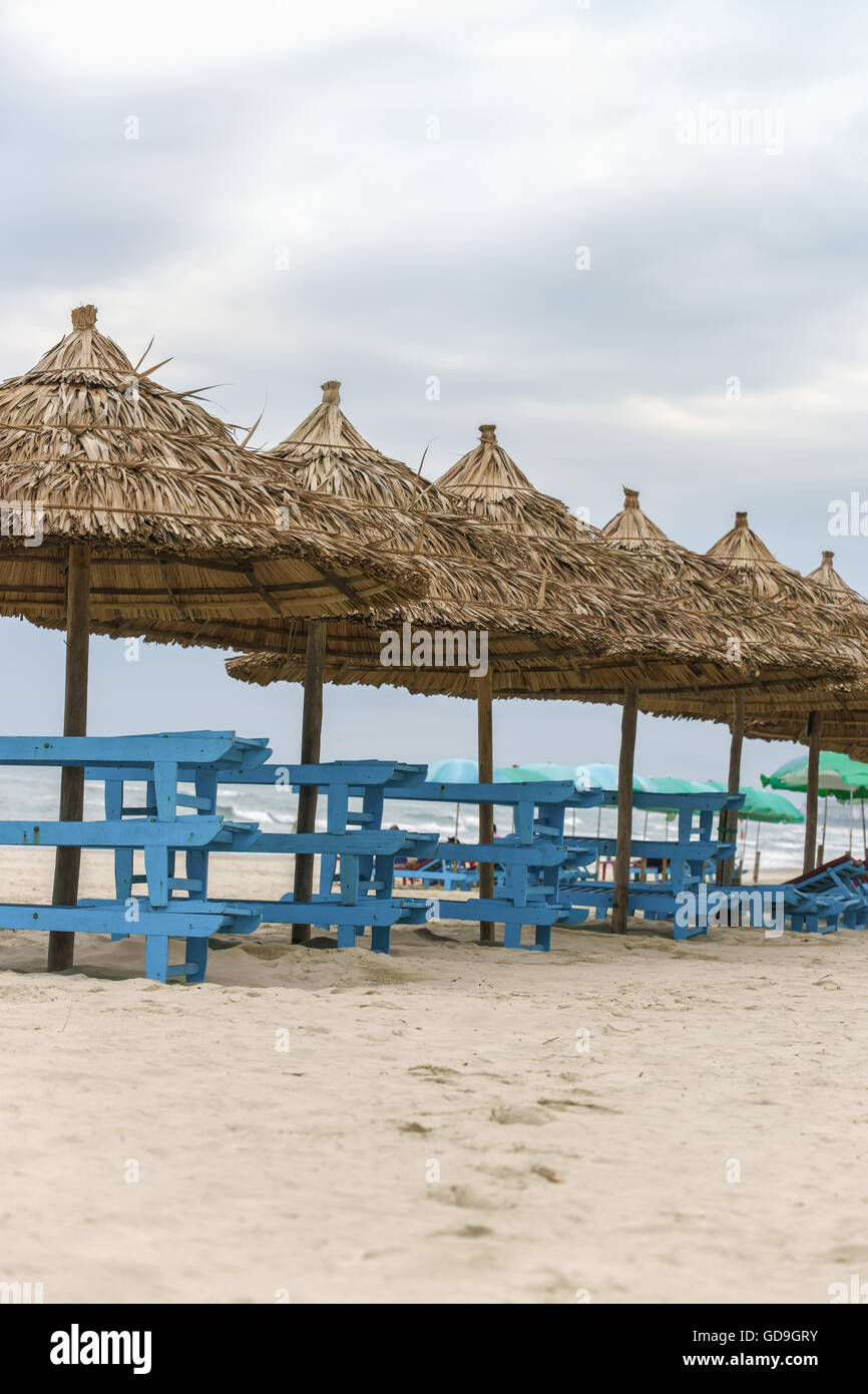 Palm shelter and sunbeds in the China Beach in Da Nang, in Vietnam. It ...