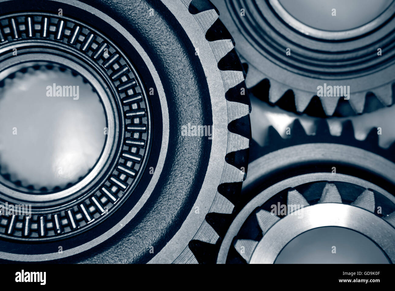 Metal cog gears joining together Stock Photo - Alamy