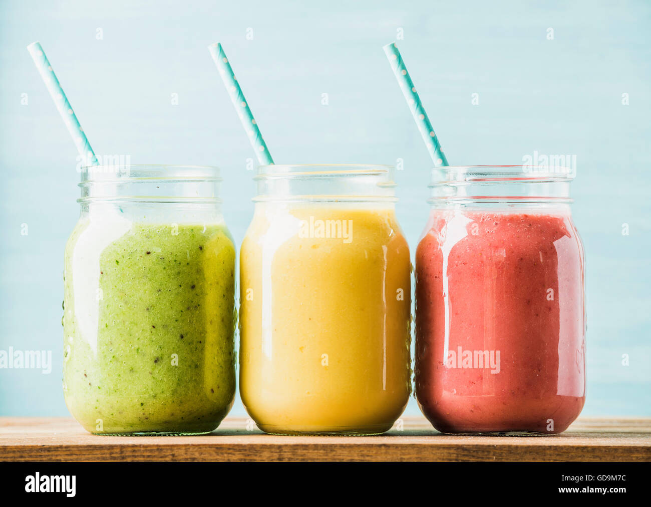 Freshly blended fruit smoothies of various colors and tastes in glass ...