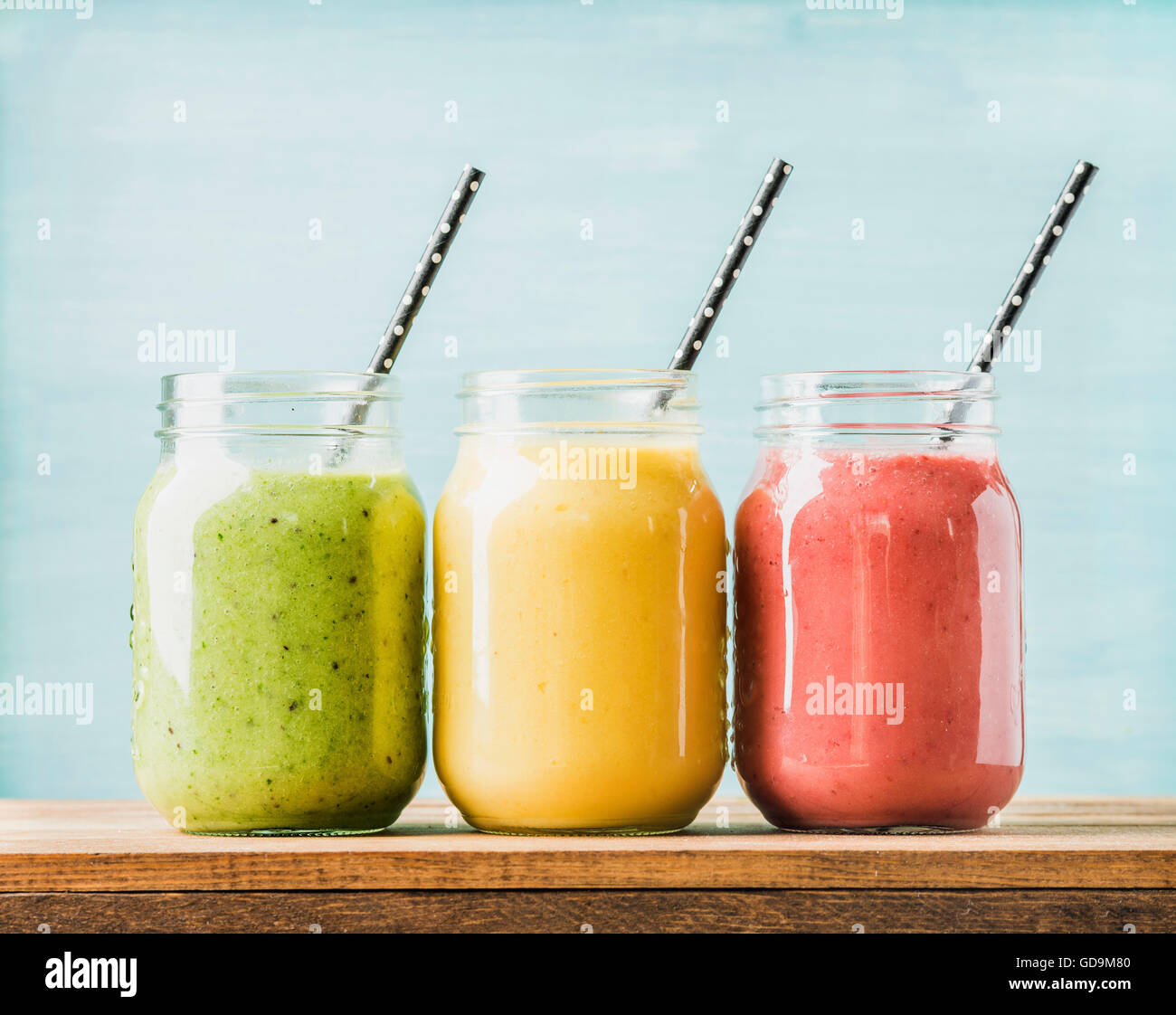 Freshly blended fruit smoothies of various colors and tastes in glass ...