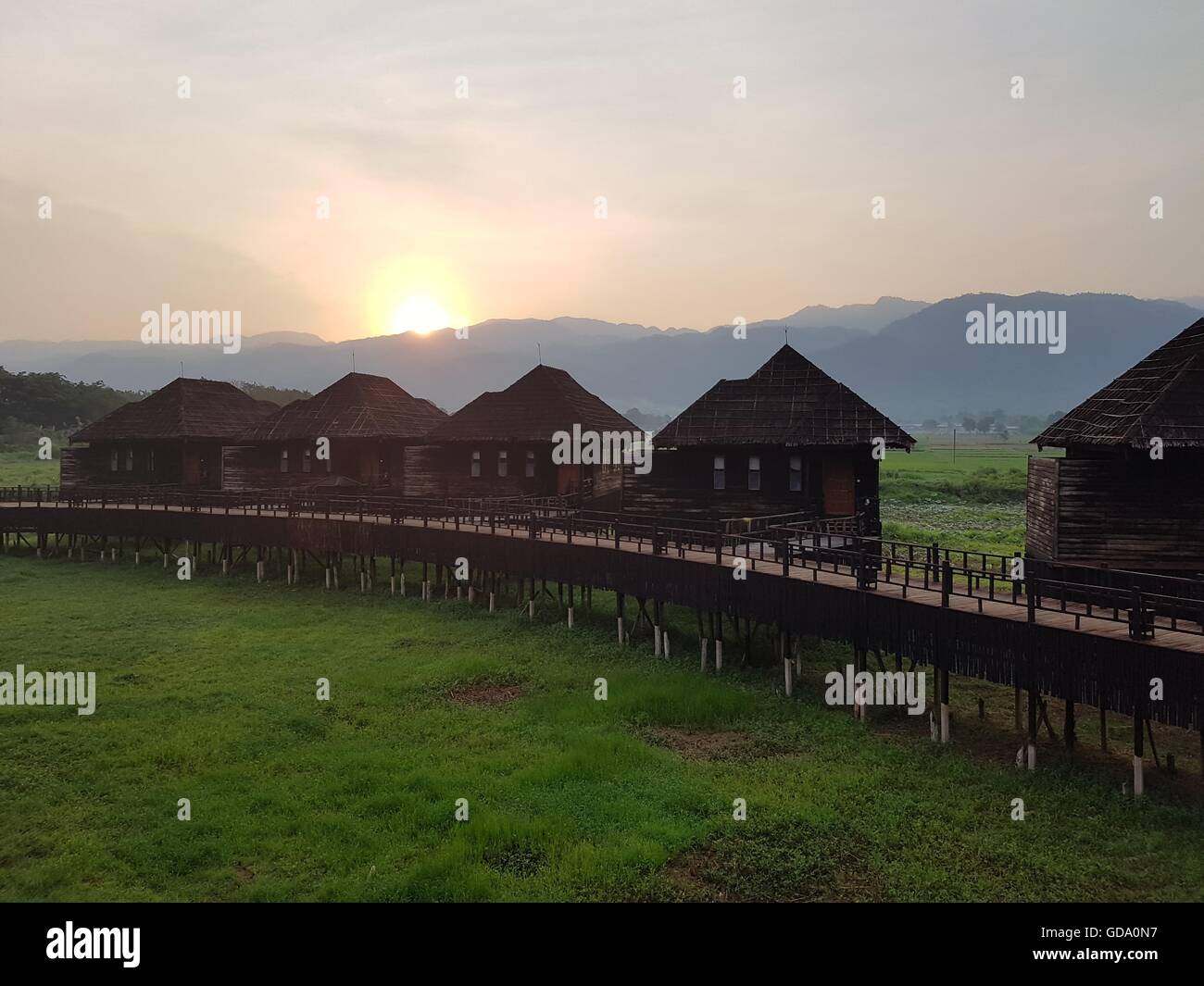 View of the sunrise over bungalows at Myanmar Treasure Resort, Inle ...