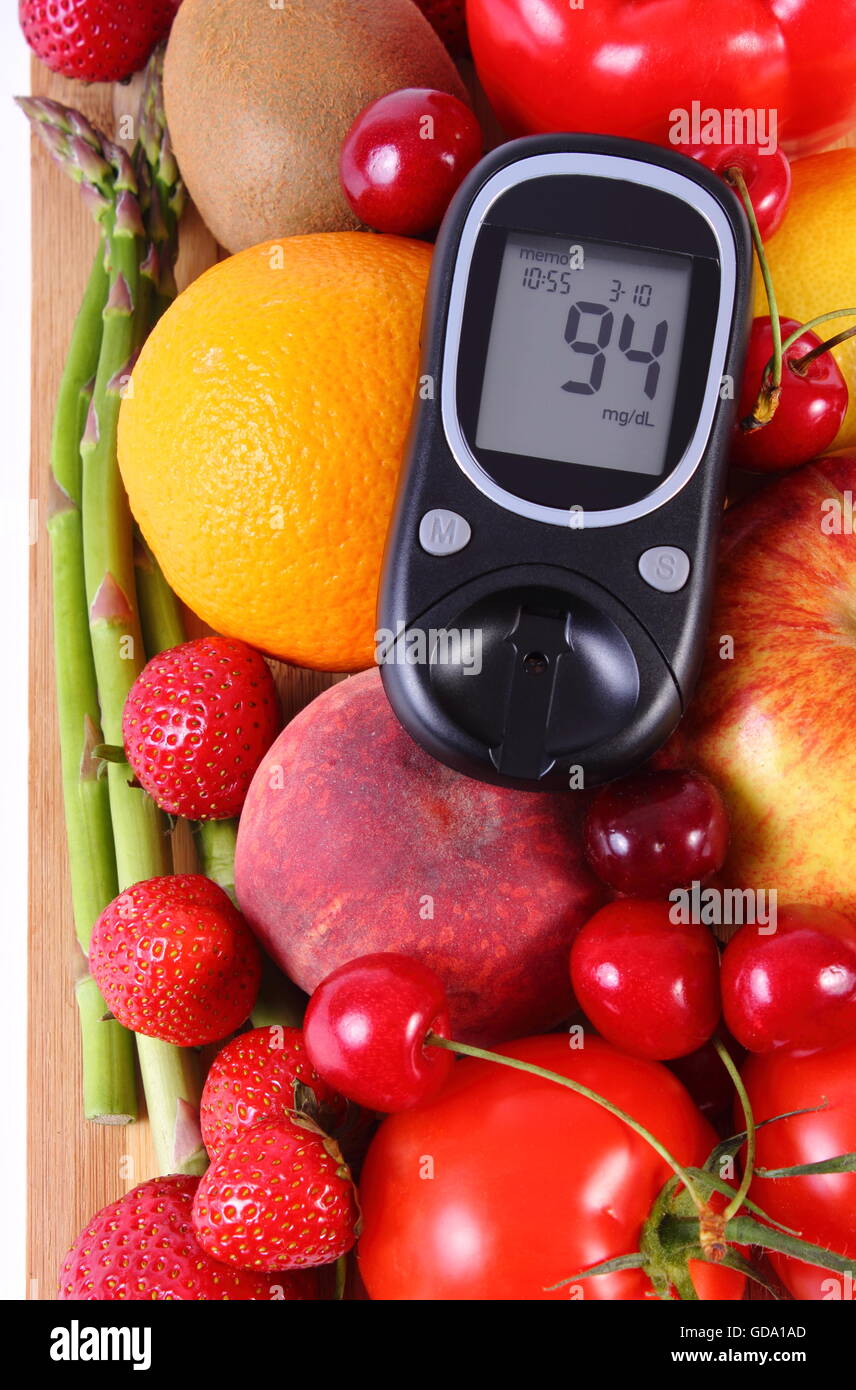 Glucose meter with fresh ripe fruits and vegetables, concept of ...