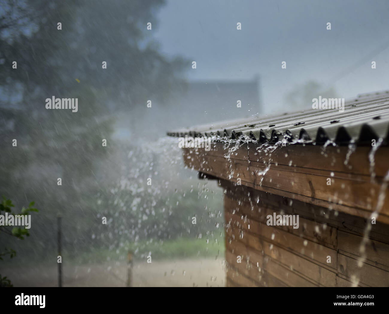 rain streams flowing from the roof Stock Photo - Alamy