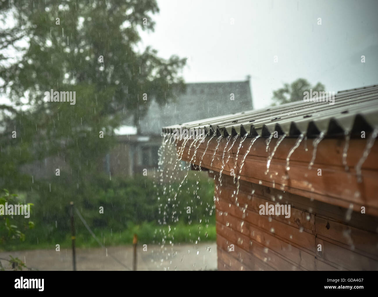 rain streams flowing from the roof Stock Photo - Alamy