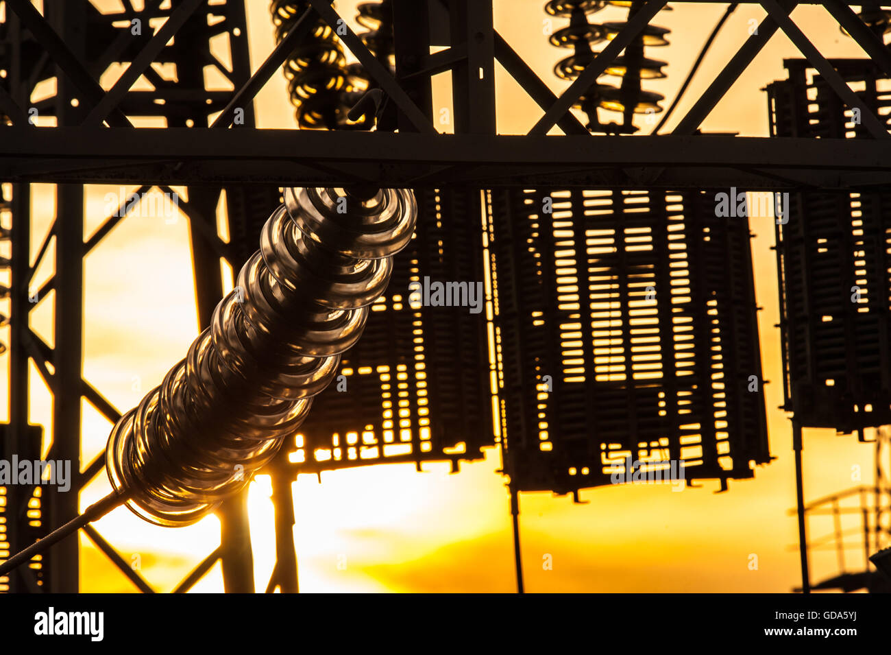 Electric lines, poles and a glass isolator in a power station, at ...