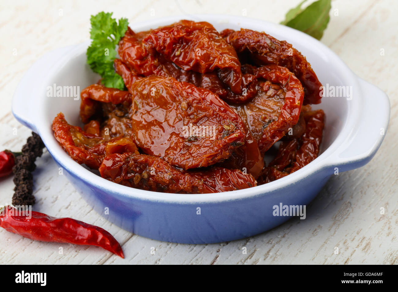 Dry tomato in olive oil with pepper Stock Photo - Alamy