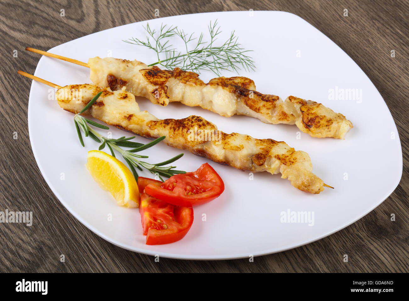 Fish skewer with dill, tomato and lemon Stock Photo - Alamy