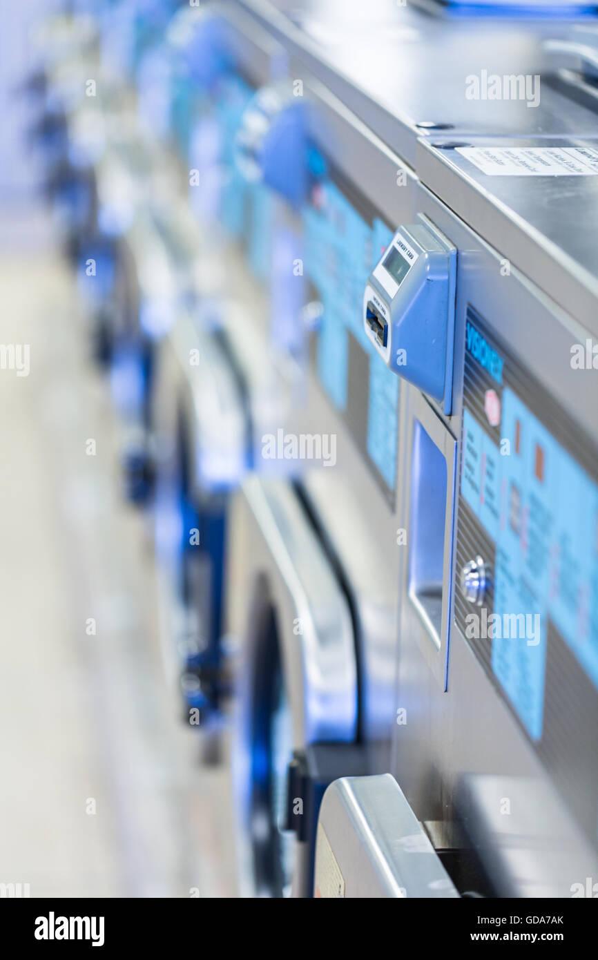 Industrial washing machines in a public laundromat Stock Photo - Alamy