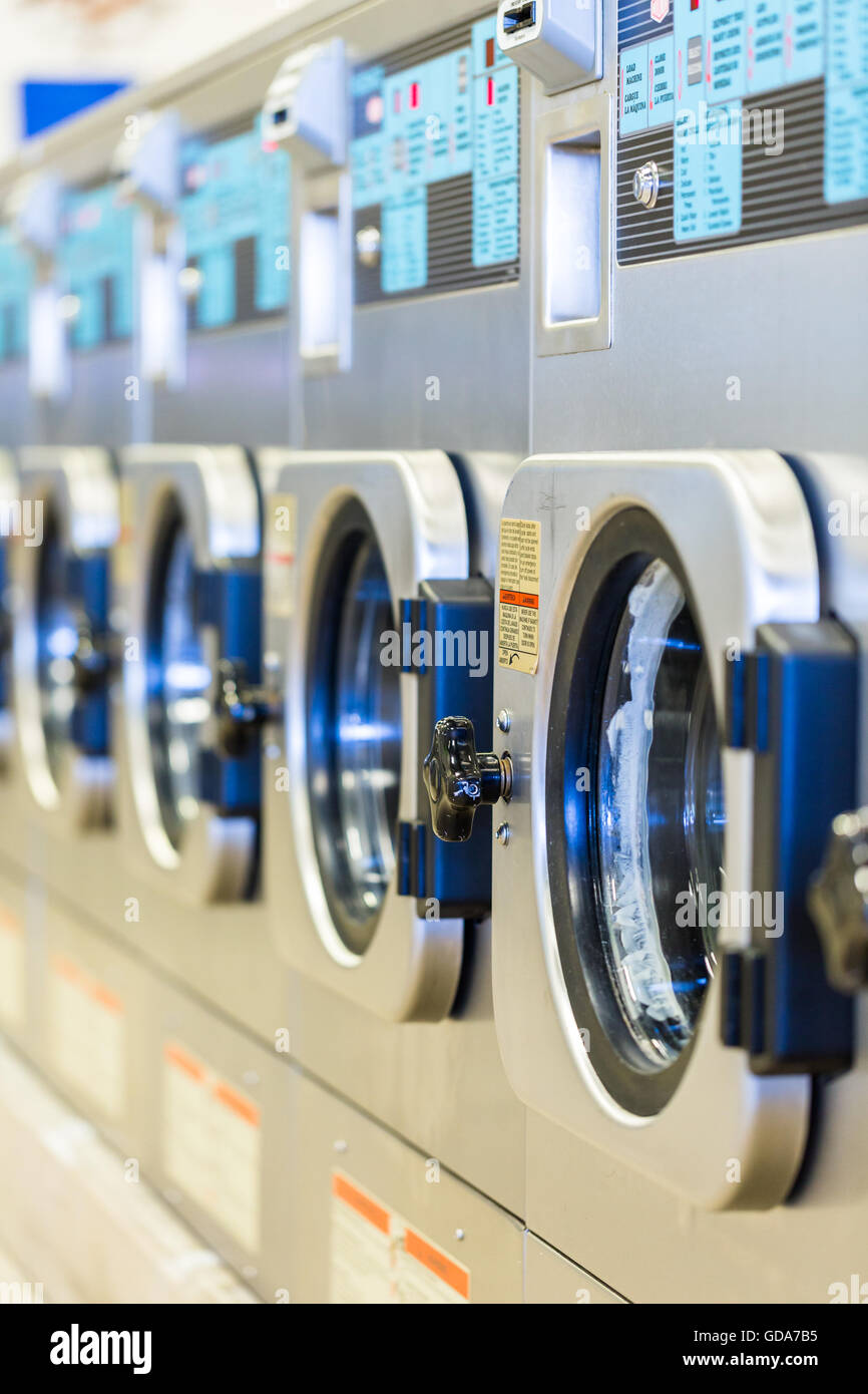 Industrial washing machines in a public laundromat Stock Photo - Alamy
