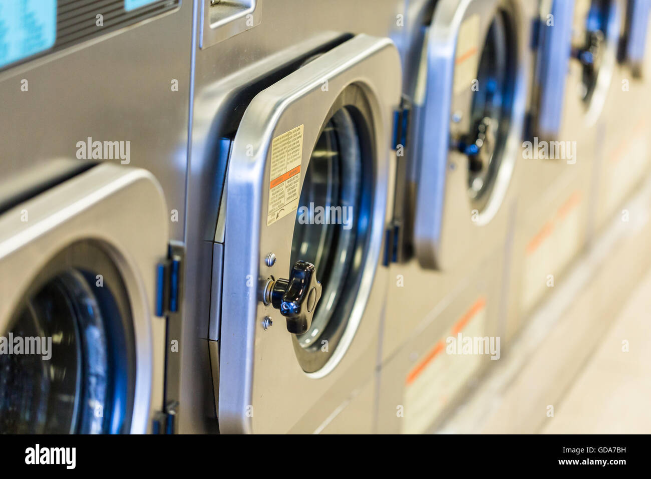Industrial washing machines in a public laundromat Stock Photo - Alamy