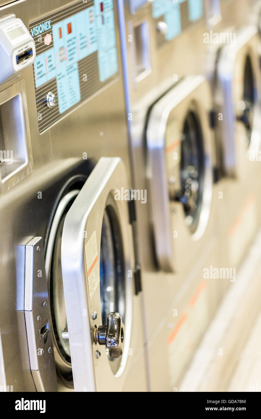 Industrial washing machines in a public laundromat Stock Photo - Alamy