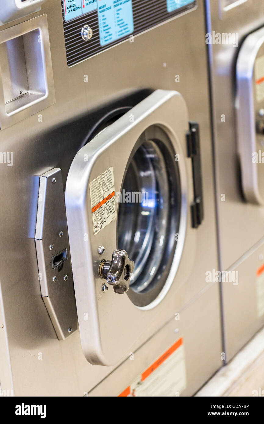 Industrial washing machines in a public laundromat Stock Photo - Alamy