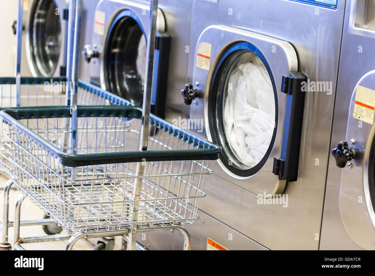 Industrial washing machines in a public laundromat Stock Photo - Alamy