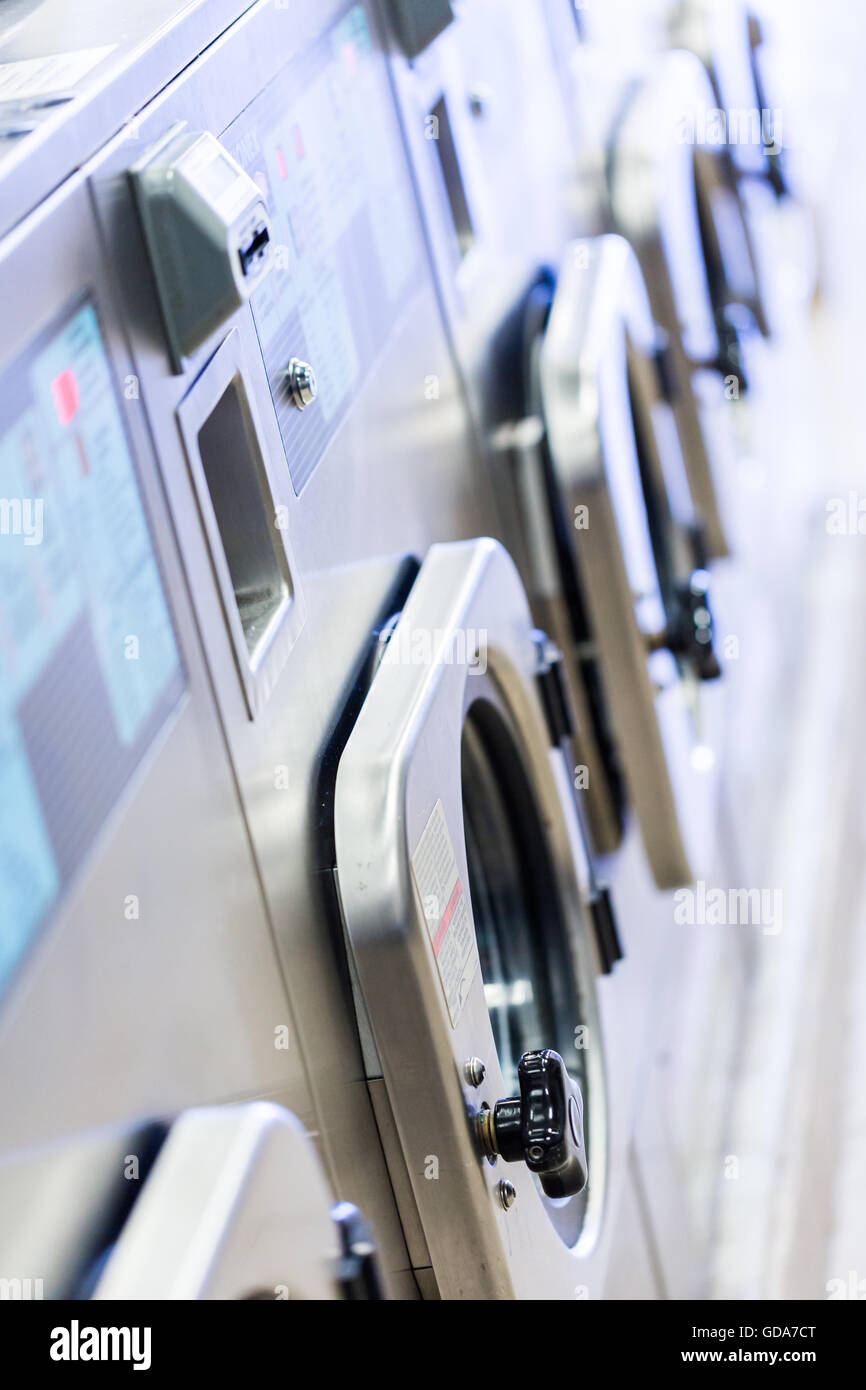 Industrial washing machines in a public laundromat Stock Photo - Alamy