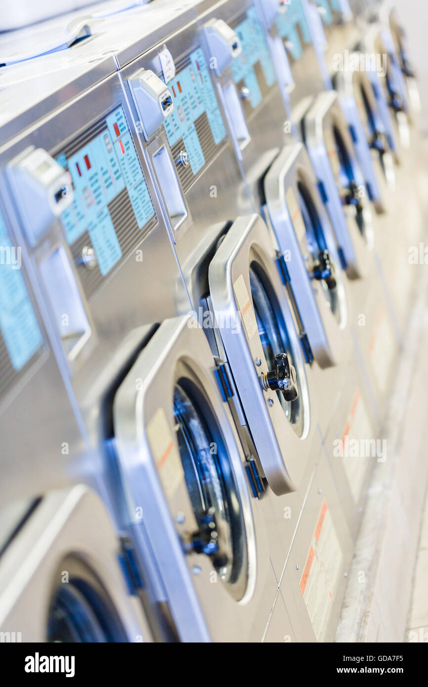 Industrial washing machines in a public laundromat Stock Photo - Alamy
