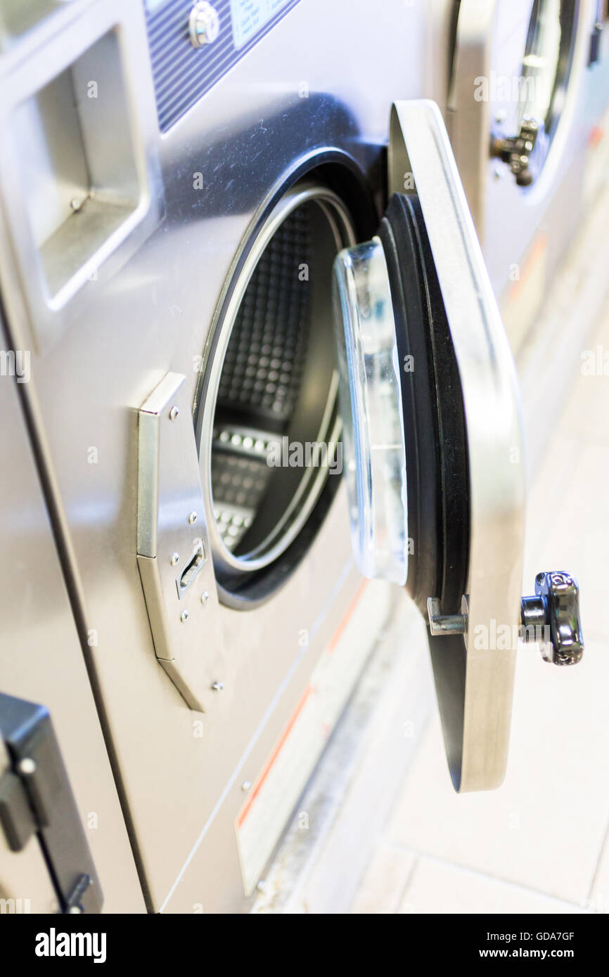 Industrial washing machines in a public laundromat Stock Photo - Alamy