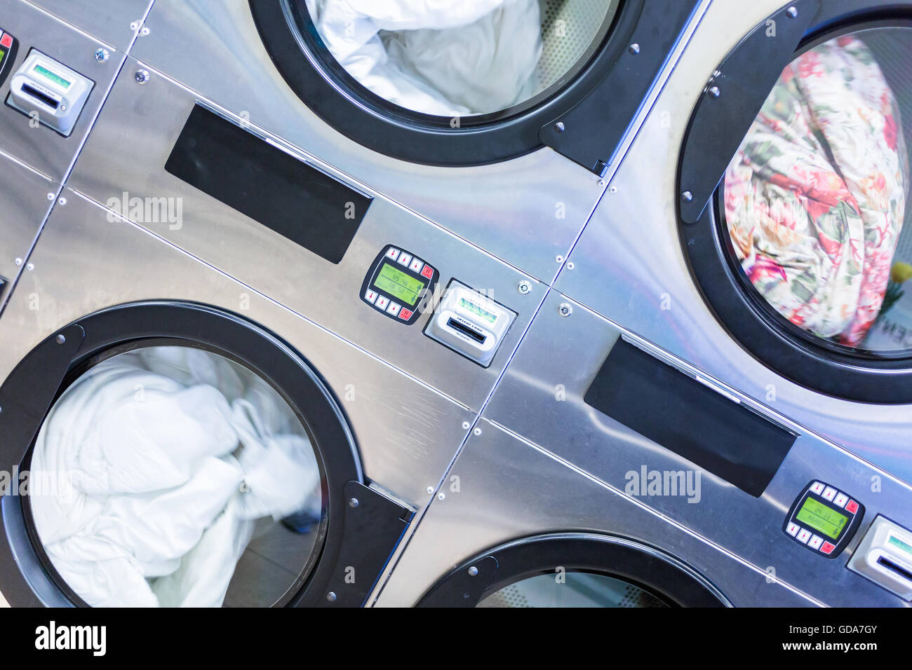 Industrial washing machines in a public laundromat Stock Photo - Alamy