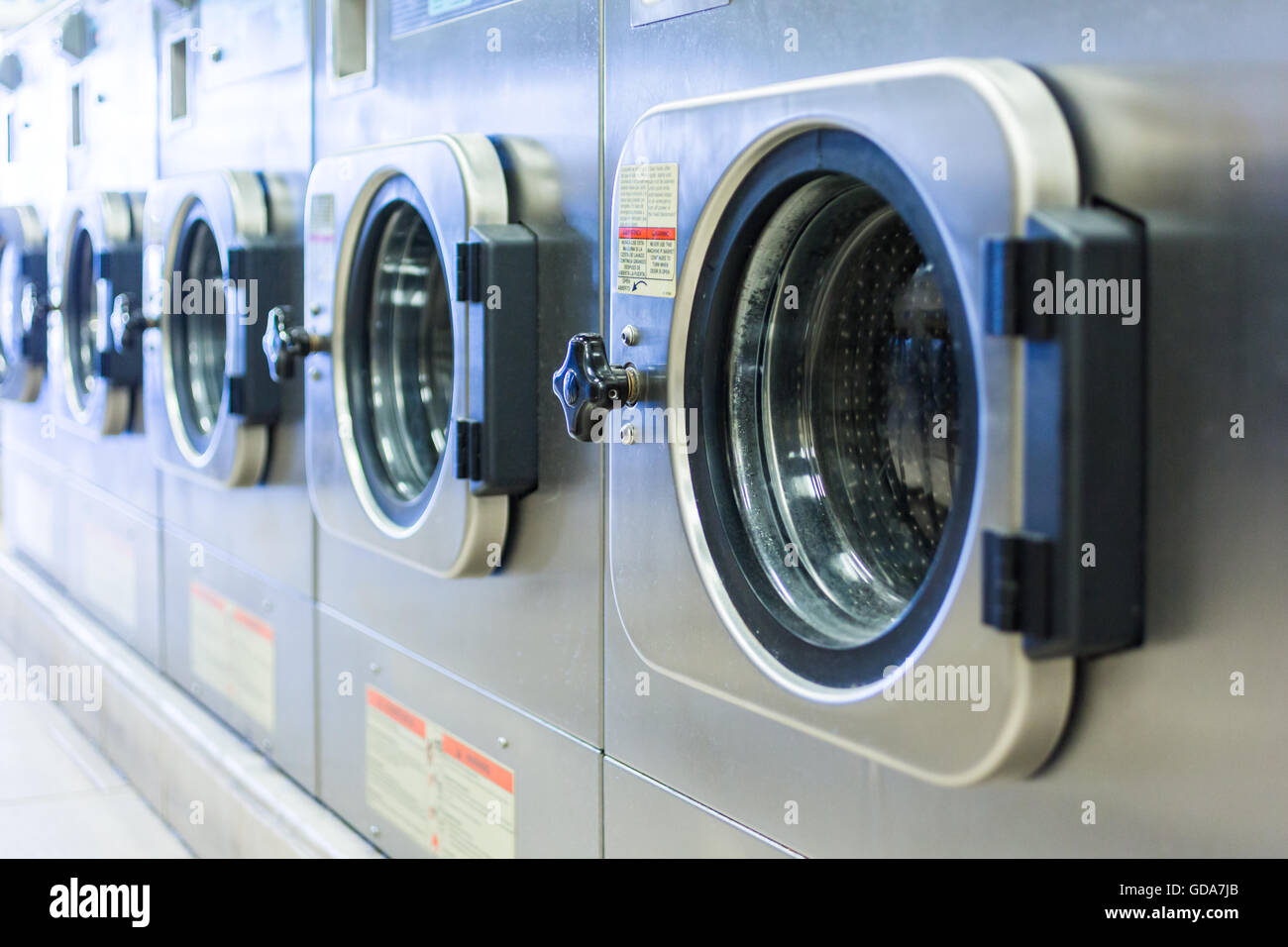 Industrial washing machines in a public laundromat Stock Photo - Alamy