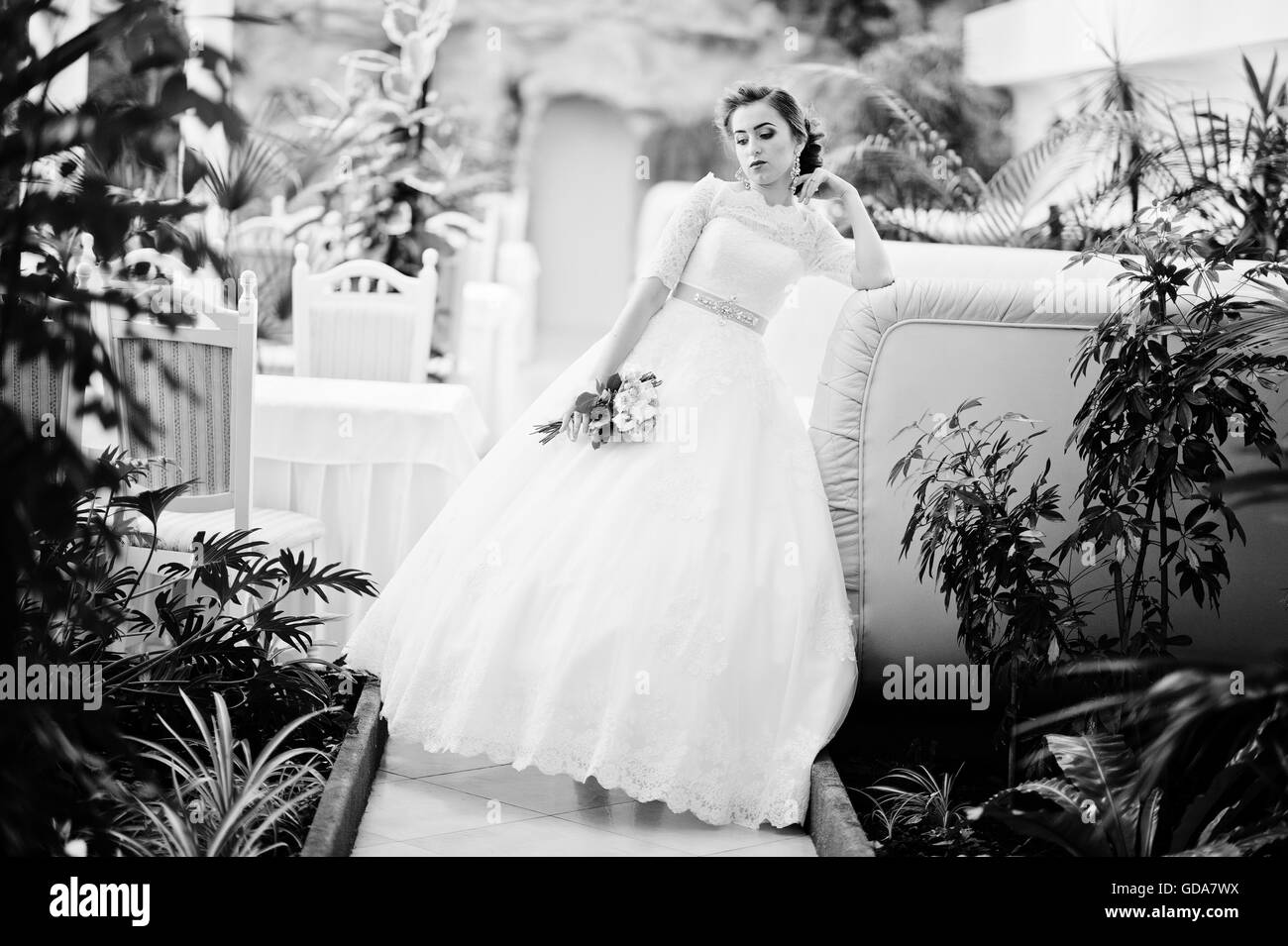 Portrait of beautiful bride at wedding hall plant in background Stock ...