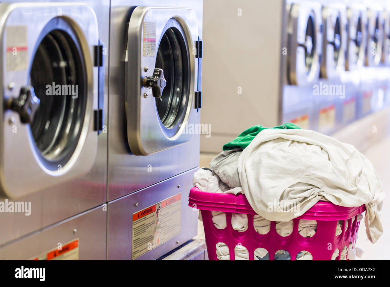 Industrial washing machines in a public laundromat Stock Photo - Alamy