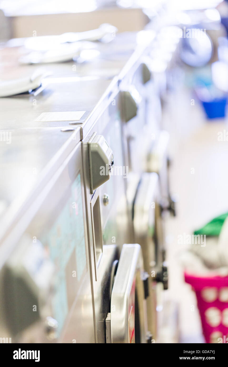 Industrial washing machines in a public laundromat Stock Photo - Alamy