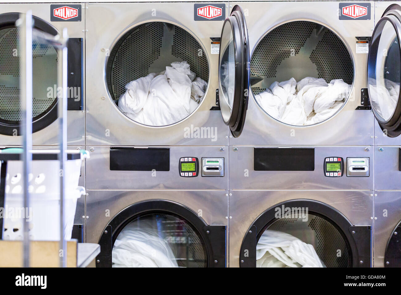 Industrial washing machines in a public laundromat Stock Photo - Alamy