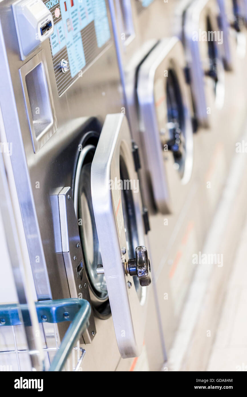 Industrial washing machines in a public laundromat Stock Photo - Alamy