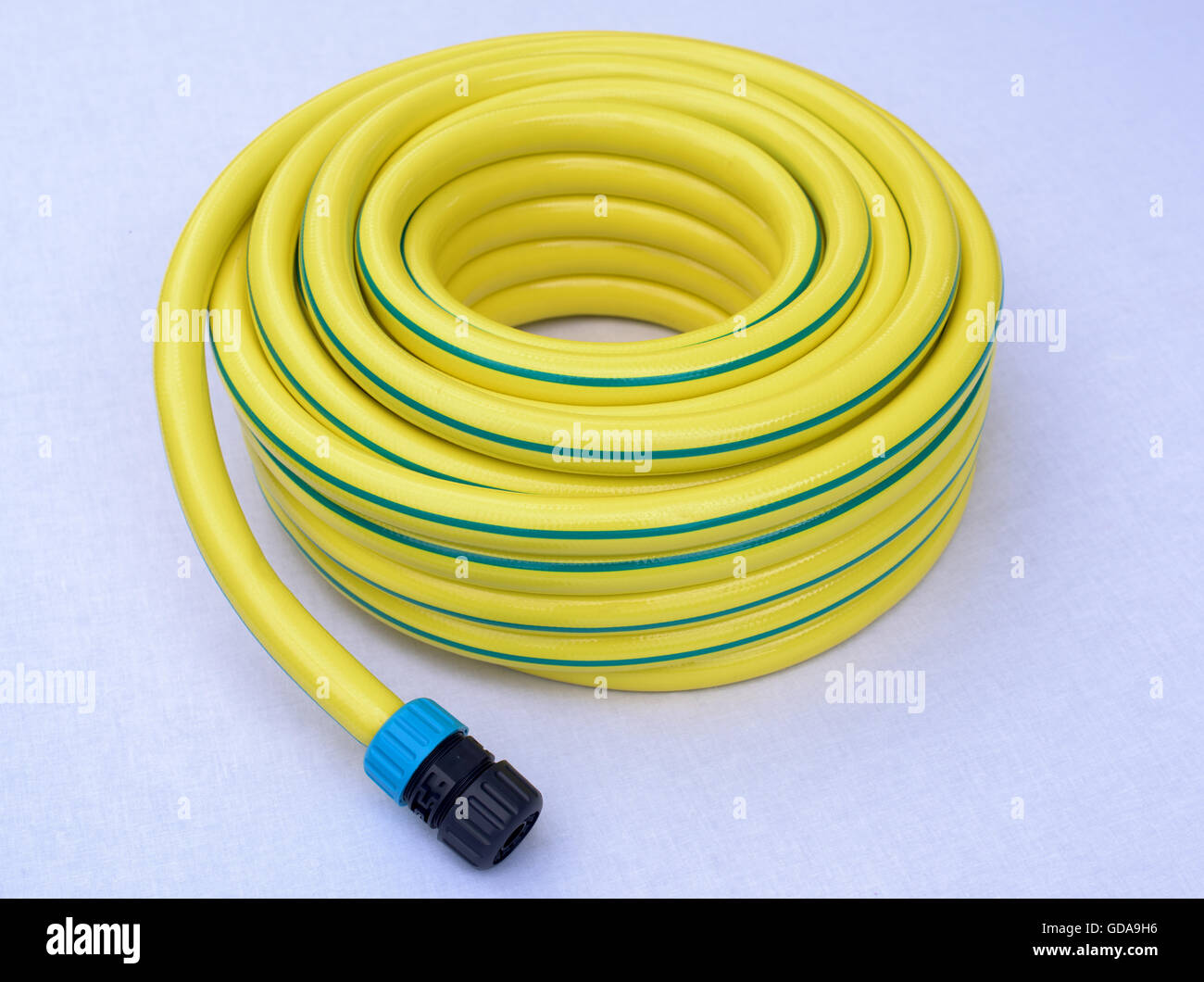 Hose-pipe with coupling on a white background Stock Photo - Alamy