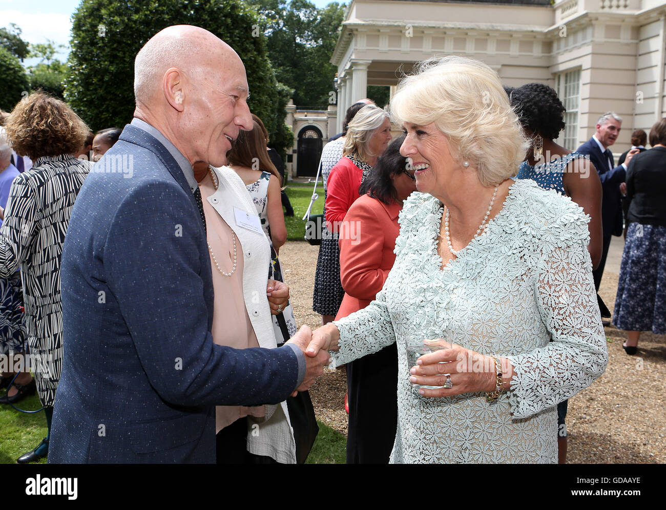 The Duchess of Cornwall speaks to Sir Patrick Stewart during a ...
