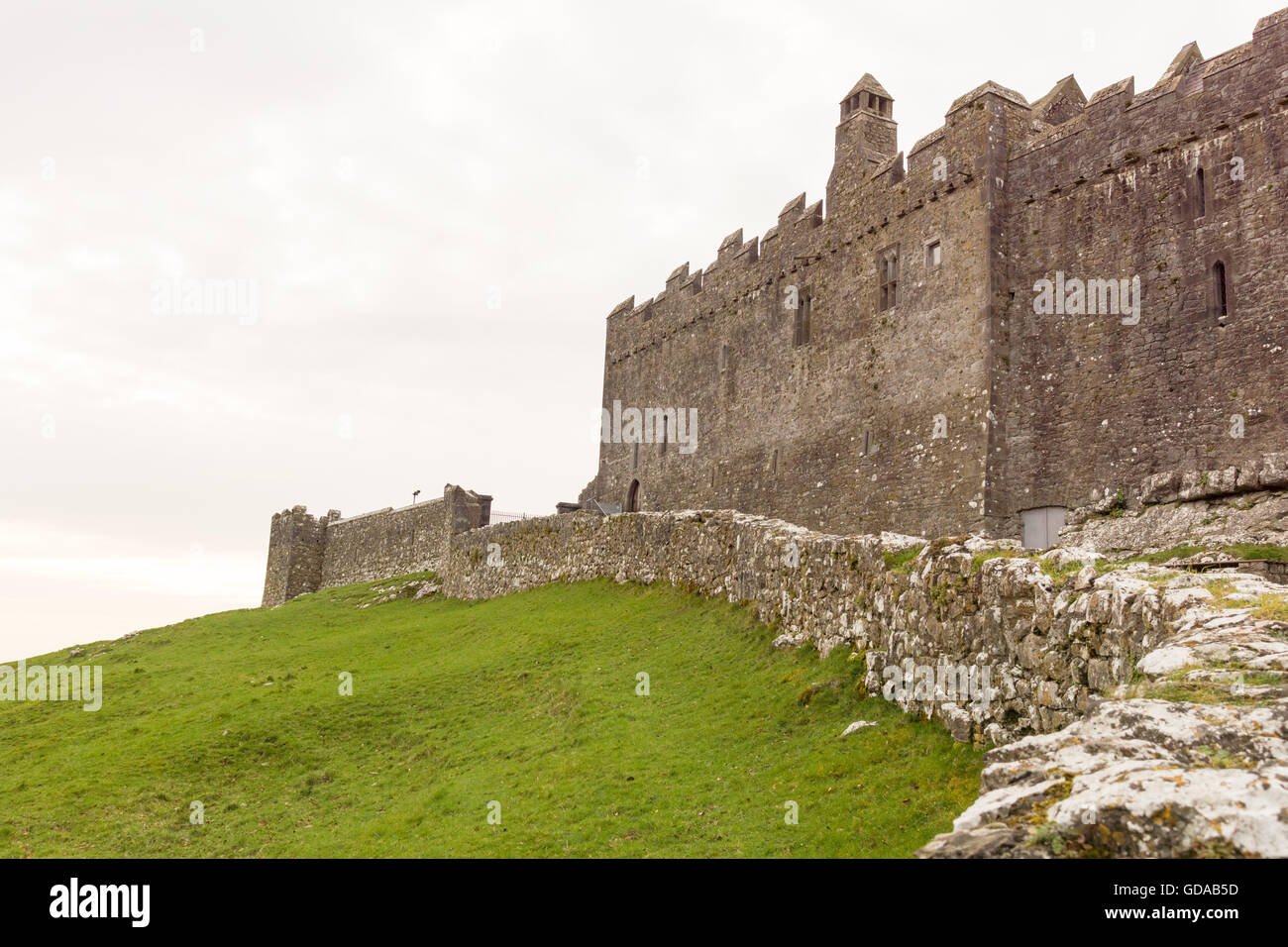 Ireland, Tipperary, Cashel, Rock of Cashel, Castle wall under gray sky ...