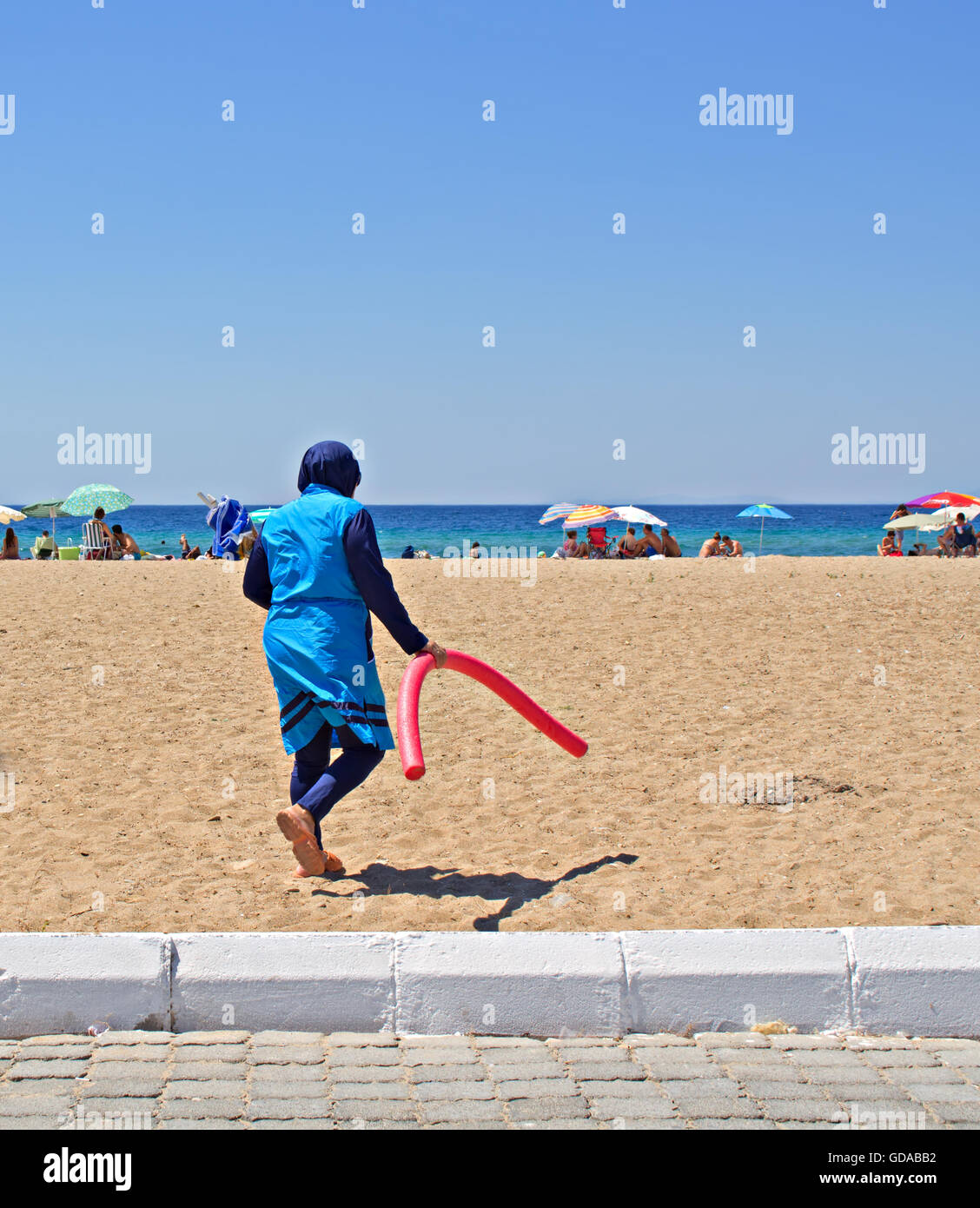Muslim woman walking on the beach in her Birkini swimwear Stock Photo ...