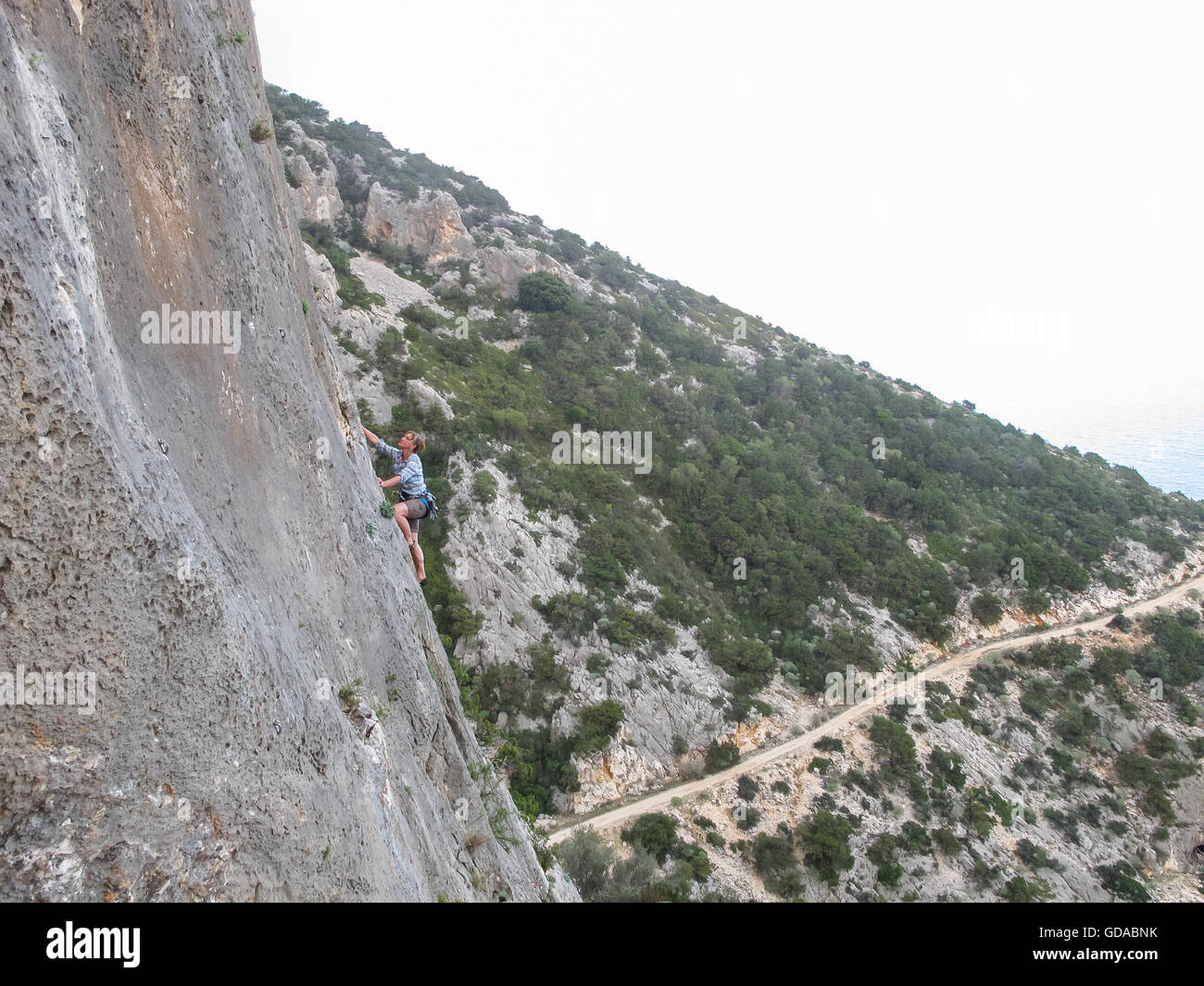 Italy, Sardinia, Climbing on steep cliff wall, Climbing on steep cliff ...