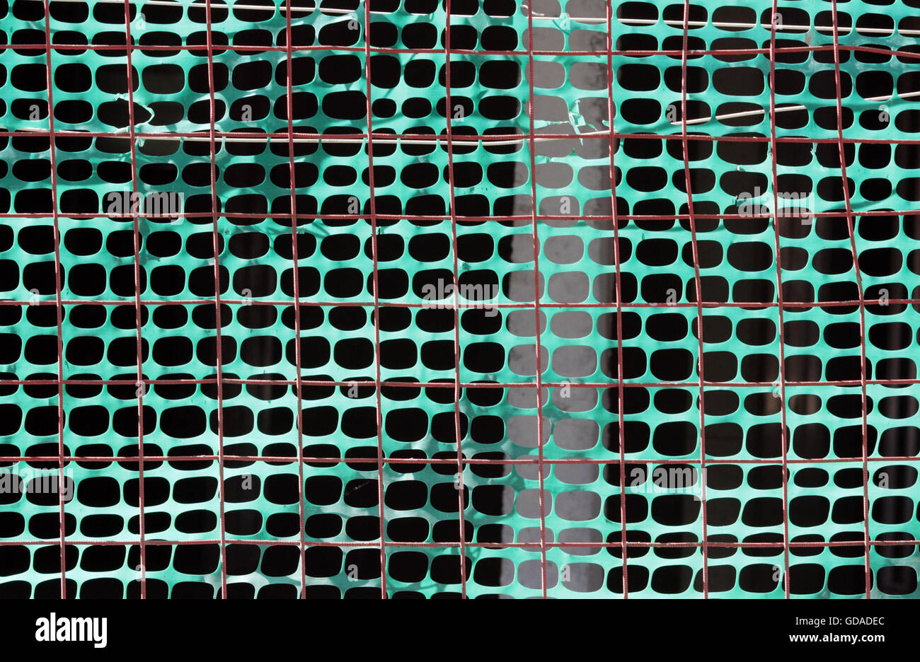 fencing of construction site with green grid Stock Photo - Alamy