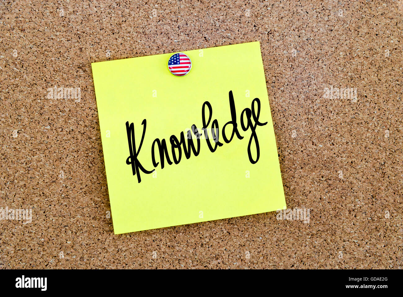 Written text Knowledge over yellow paper note pinned on cork board ...