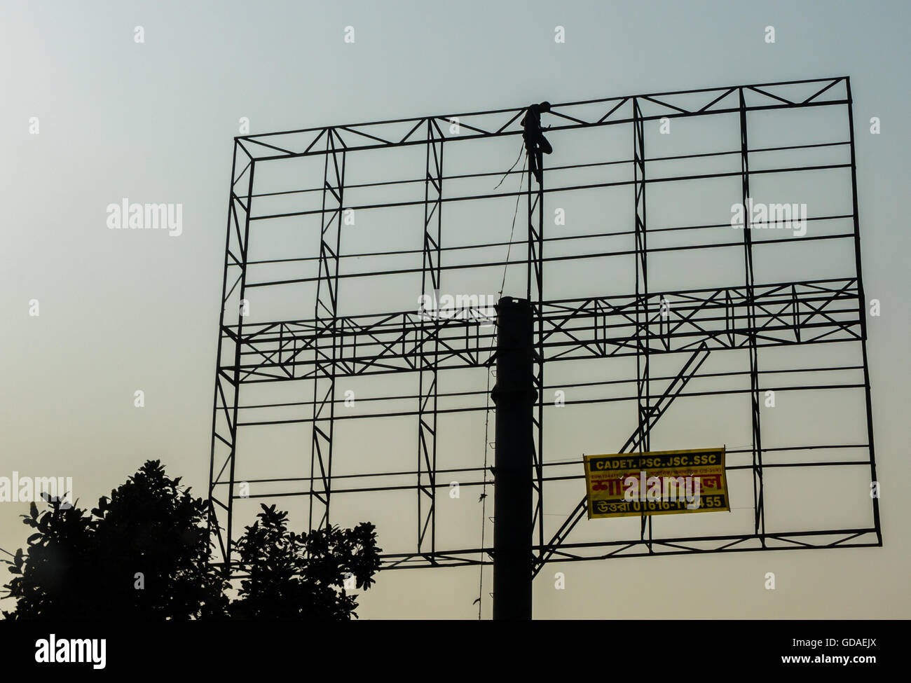 Man working on an advertising sign in Dhaka Stock Photo - Alamy