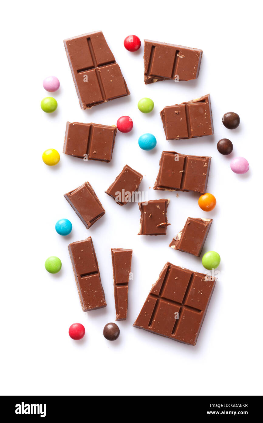 Broken chocolate bar and colorful candy sweets. Isolated on white ...