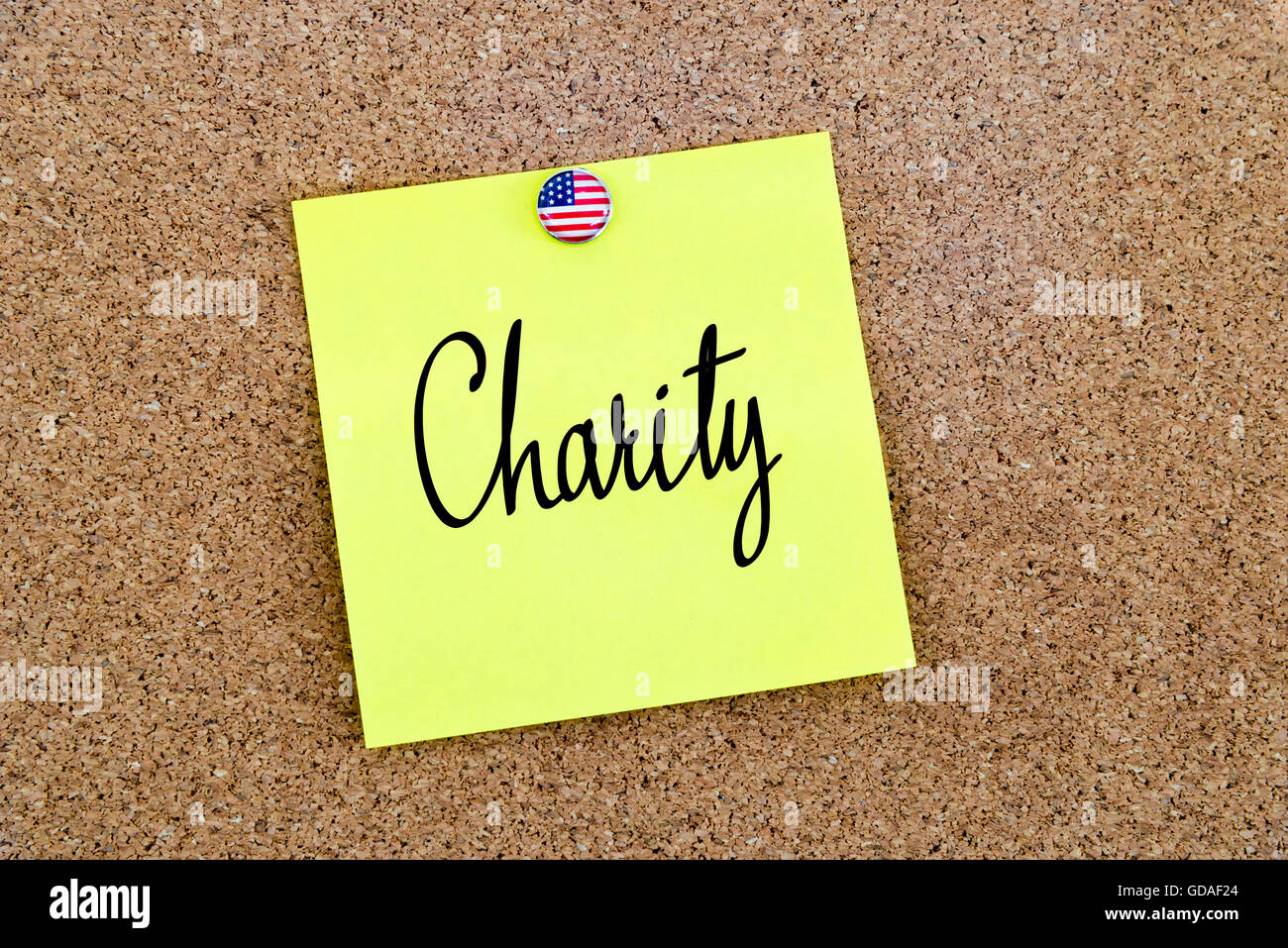 Written text Charity over yellow paper note pinned on cork board Stock ...