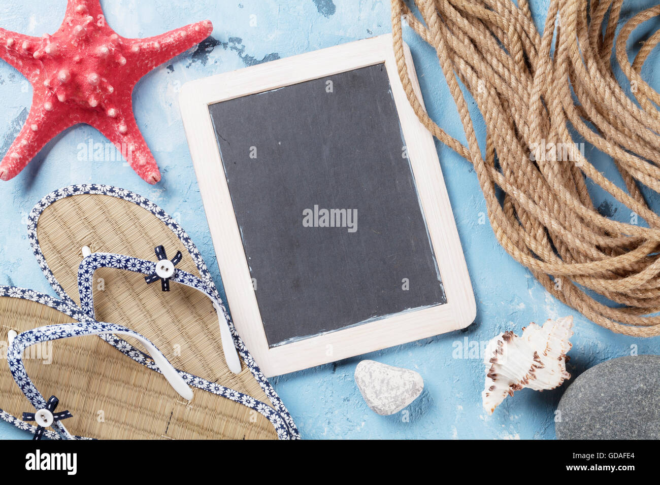 Beach vacation background. Flip-flops, seashells and blackboard for ...