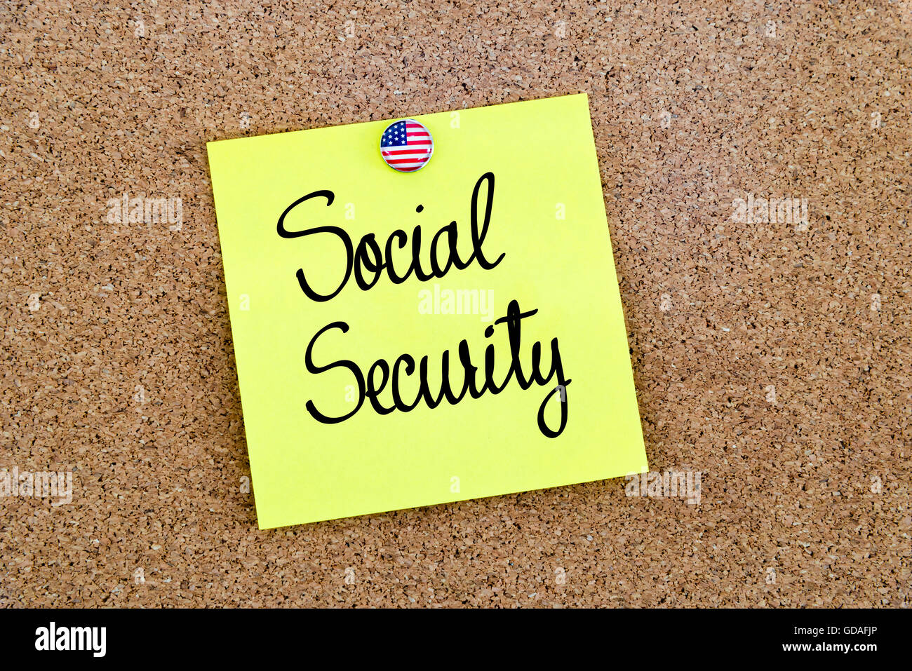 Written text Social Security over yellow paper note pinned on cork ...