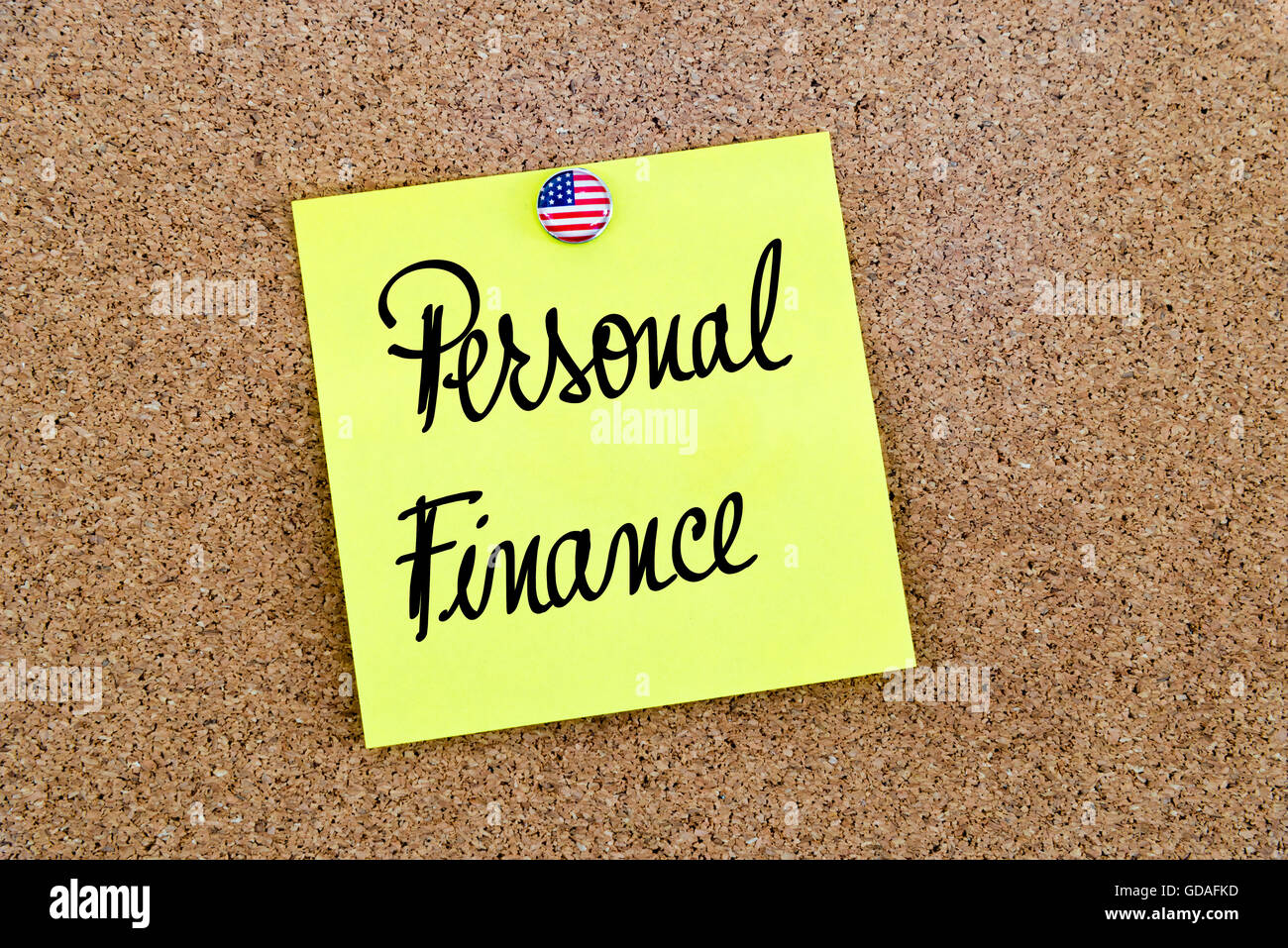 Written text Personal Finance over yellow paper note pinned on cork ...