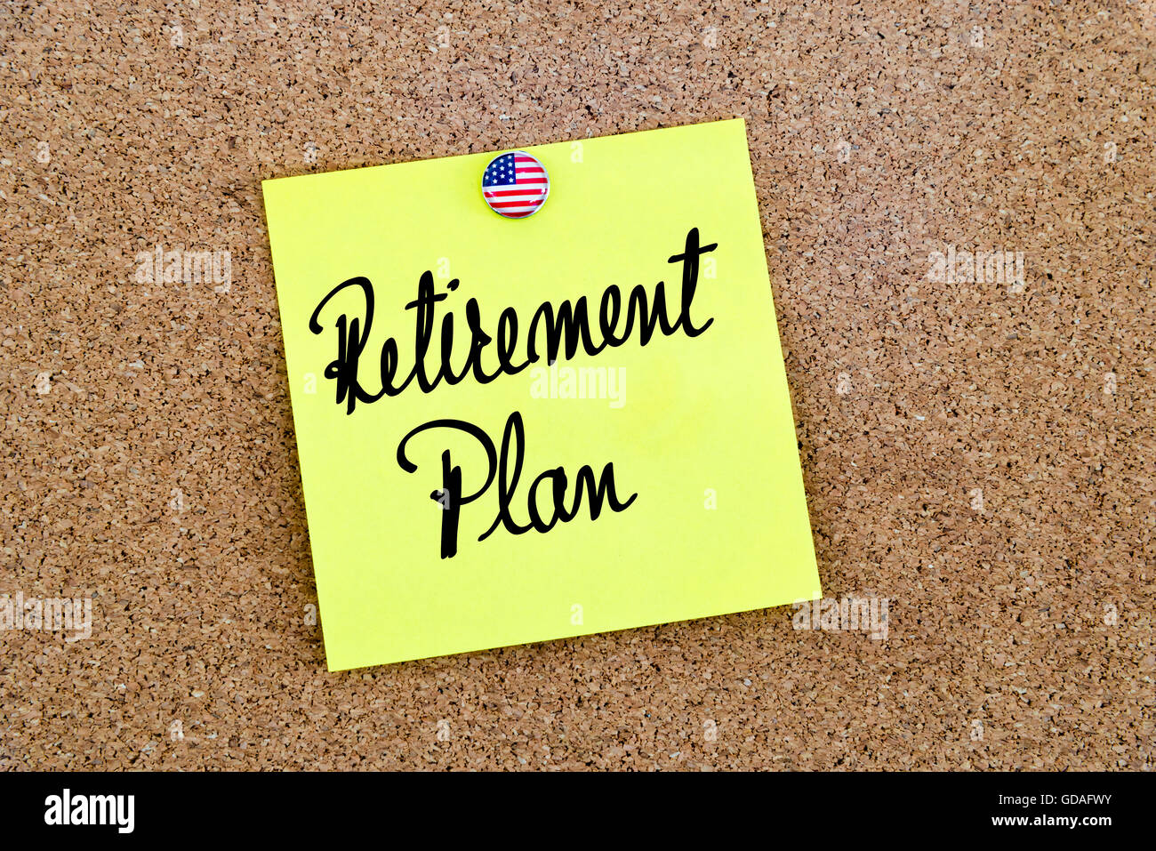 Written text Retirement Plan over yellow paper note pinned on cork ...