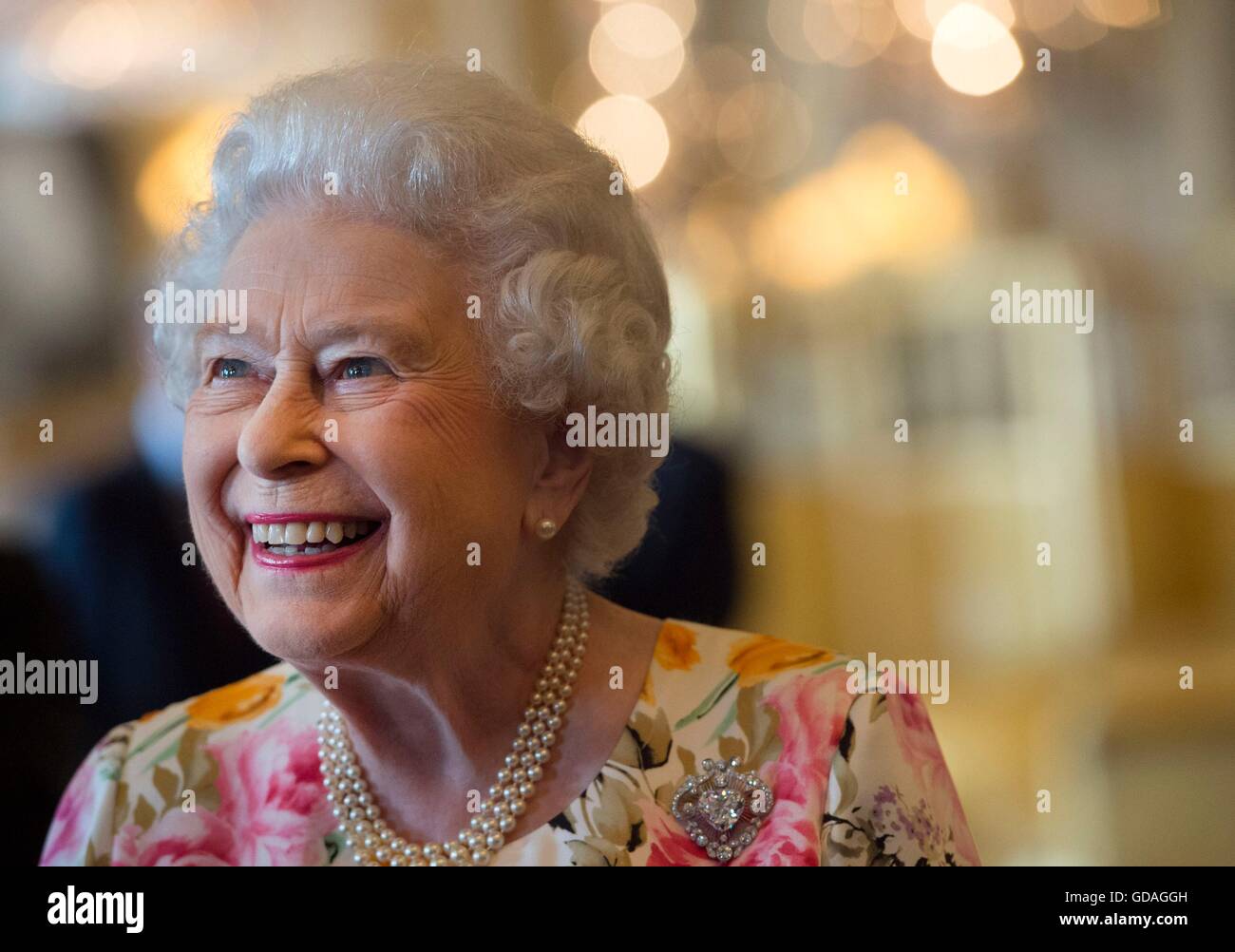 Queen Elizabeth II speaks to guests during a reception for the winners ...