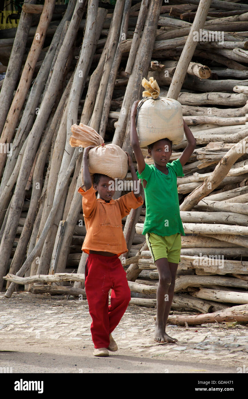 Children working child labour carrying hi-res stock photography and ...
